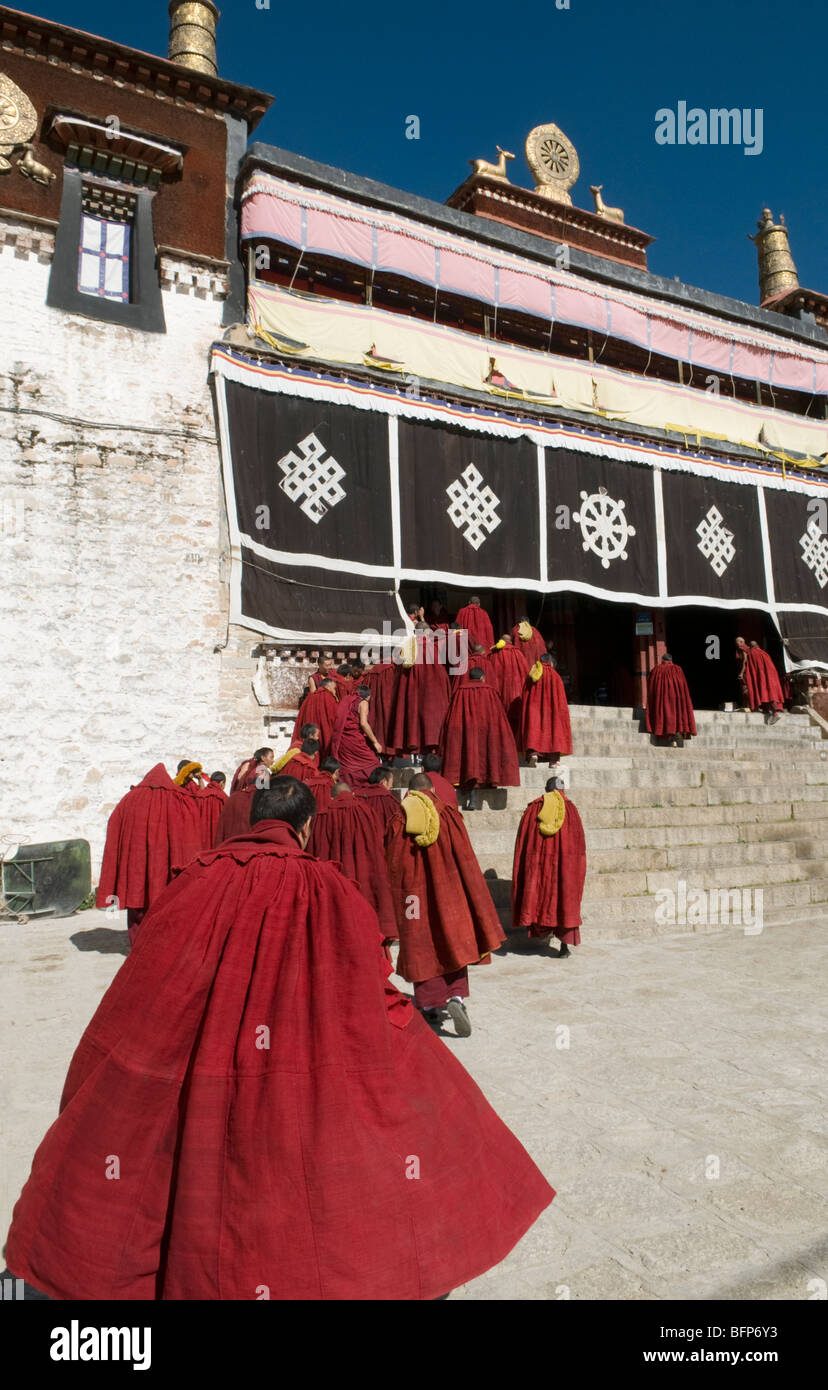 Monks in front of the main prayer hall at the famous Drepung Monastery ...