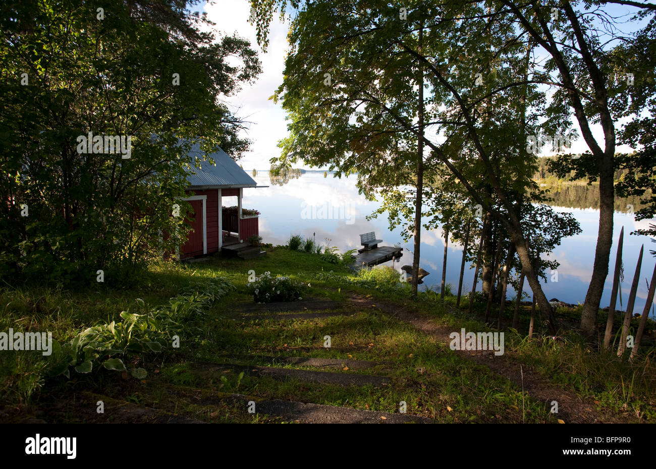 Footpath to a small red wooden sauna by a lake , Finland Stock Photo ...