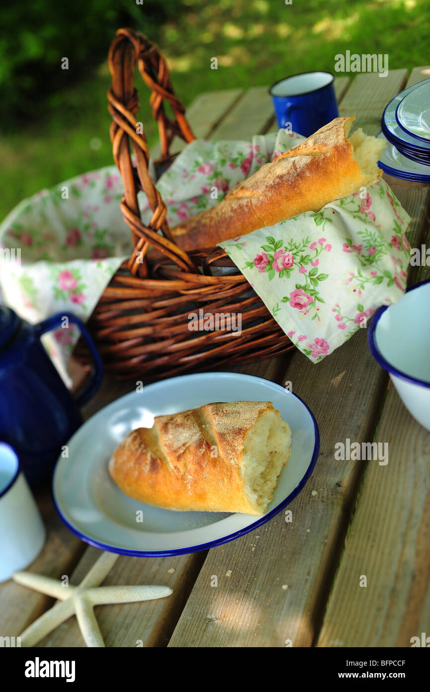 bread laid out for breakfast, on a picnic table with a basket Stock ...