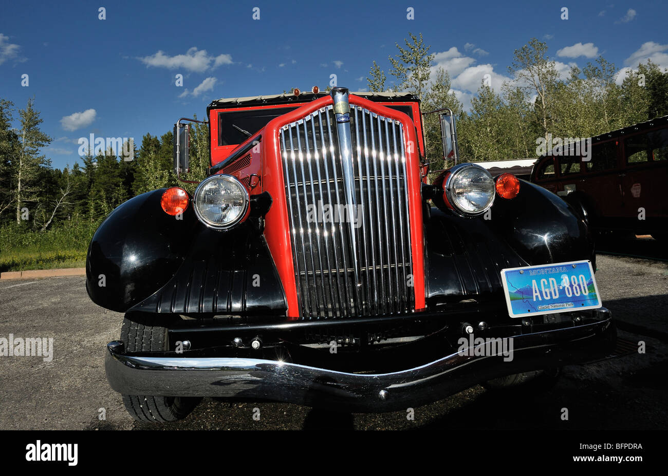 Red Tour Bus of the Glacier national park, Montana Stock Photo - Alamy