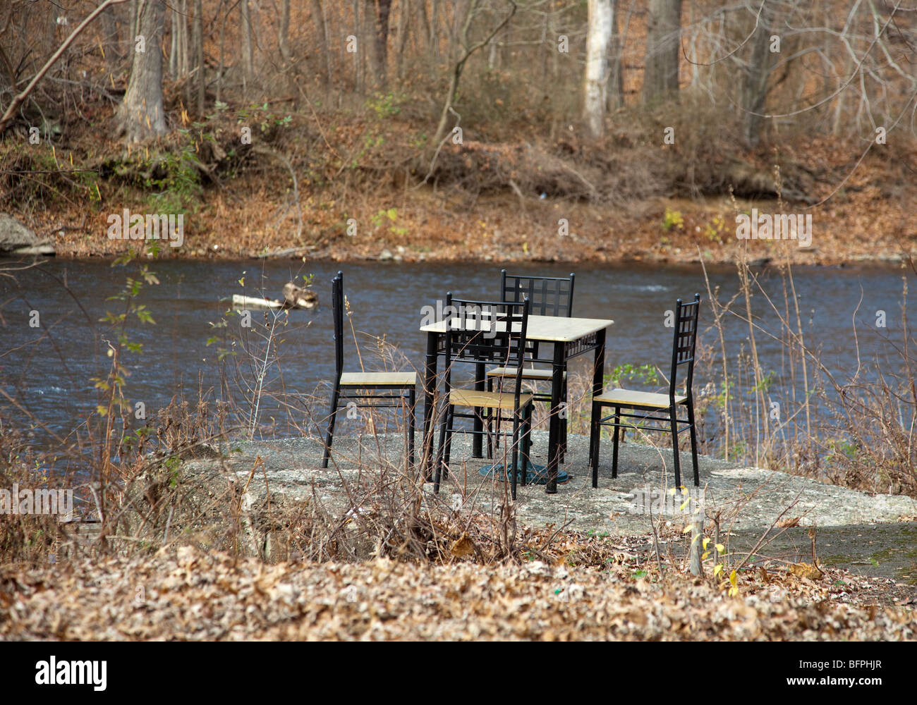 Table and chairs by the side of a river Stock Photo - Alamy