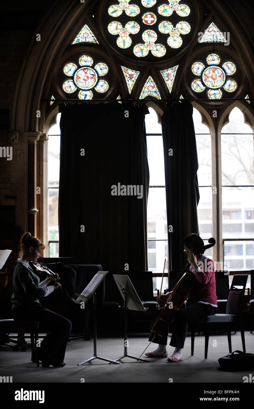 Girls from Cheltenham Ladies' College practise playing their violin and ...