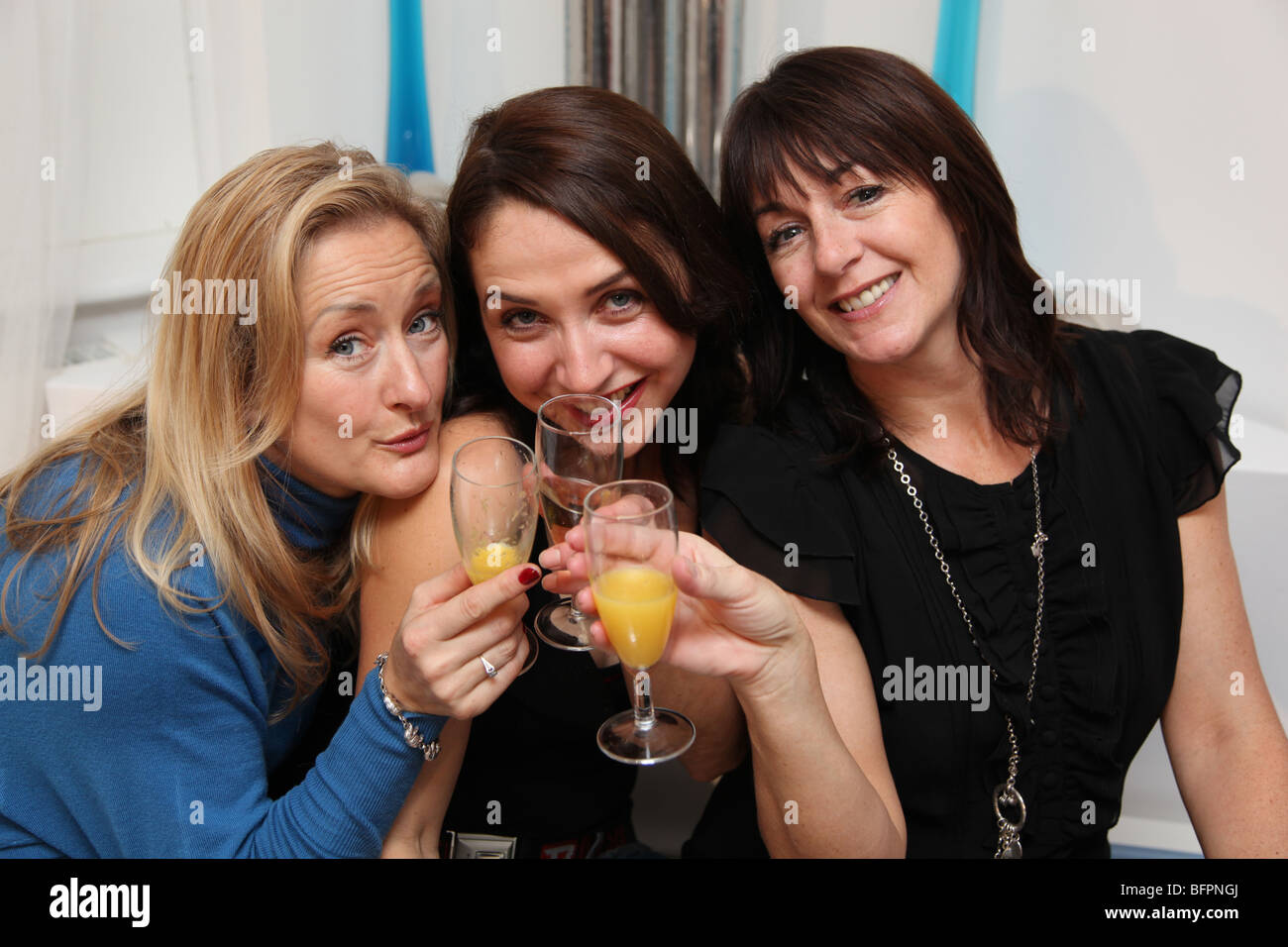 3 ladies celebrating Stock Photo - Alamy