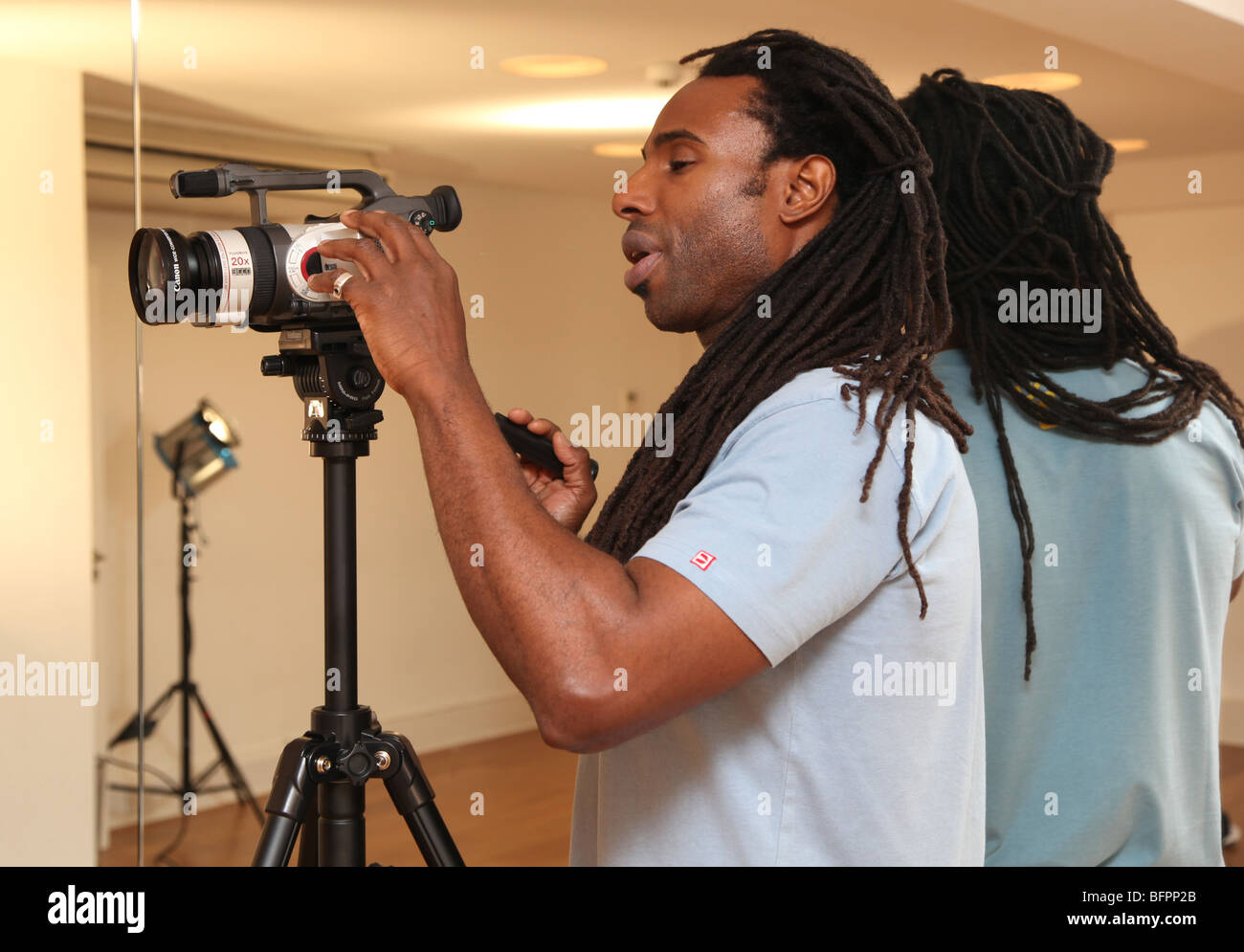 Man using a video camera Stock Photo - Alamy