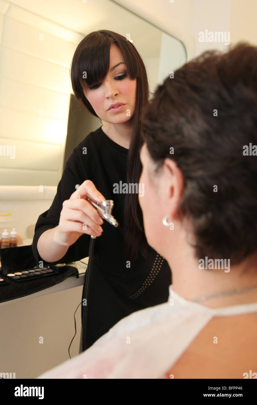 Lady having her makeup done by a professional makeup artist Stock Photo ...