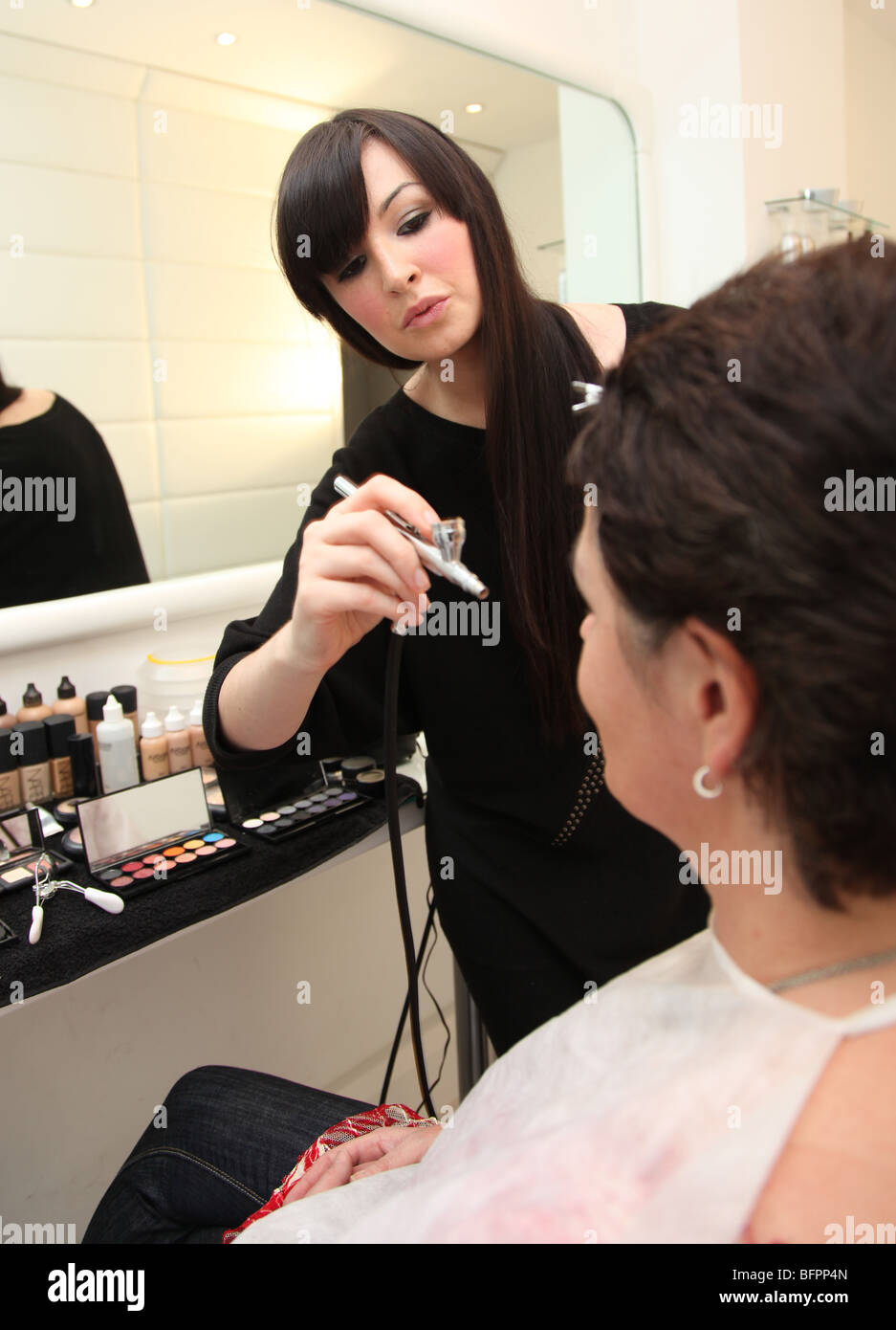 Lady having her makeup done by a professional makeup artist Stock Photo ...