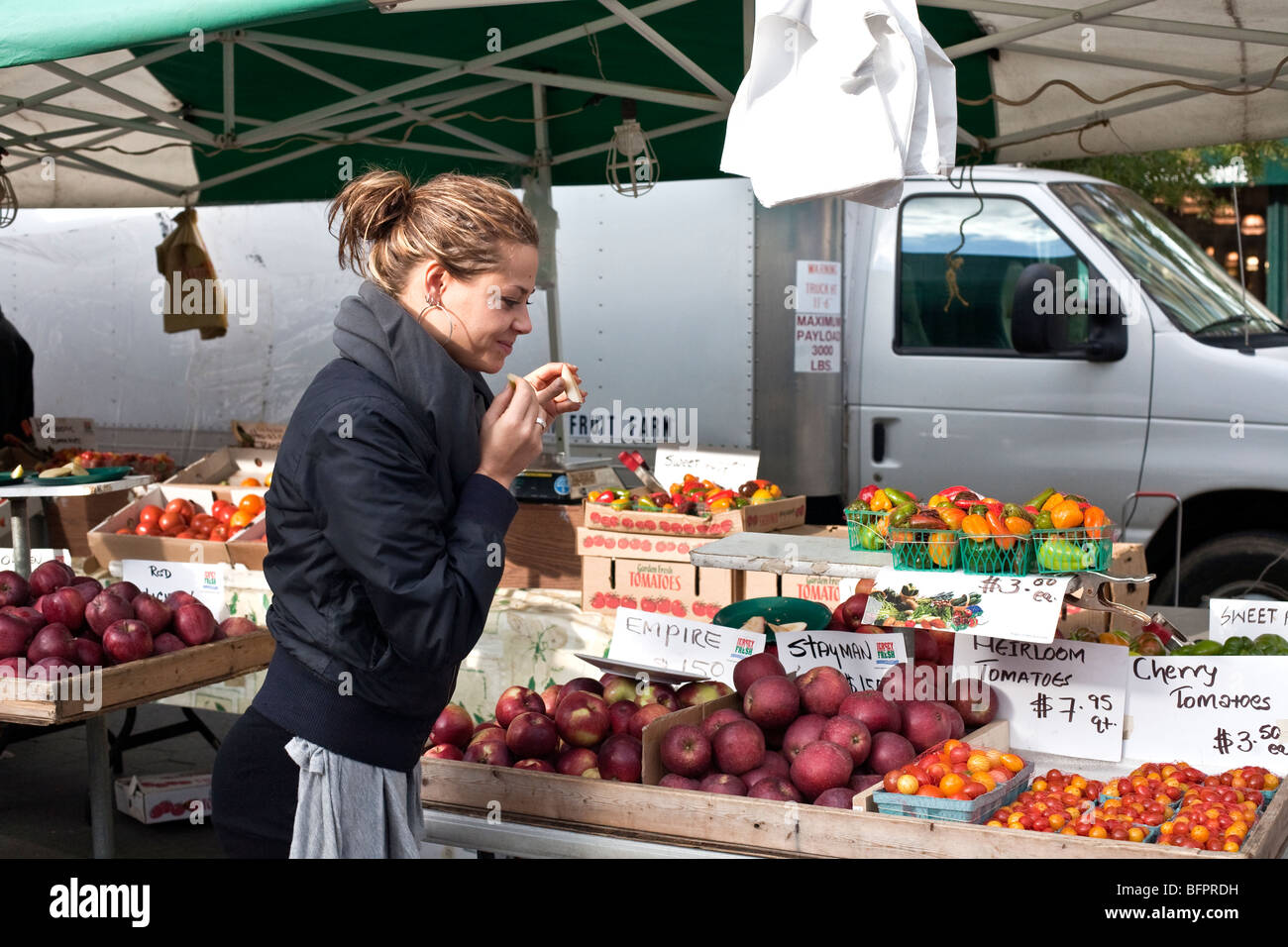 slender pretty girl wearing windbreaker face studs & top knot is ...