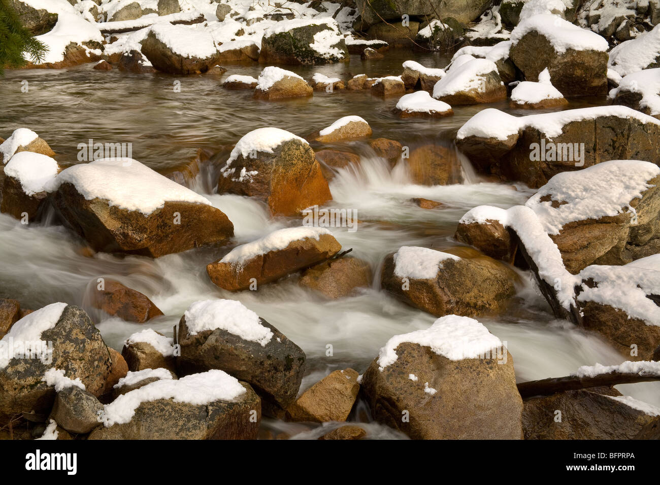 Stream flowing through snow covered hi-res stock photography and images ...