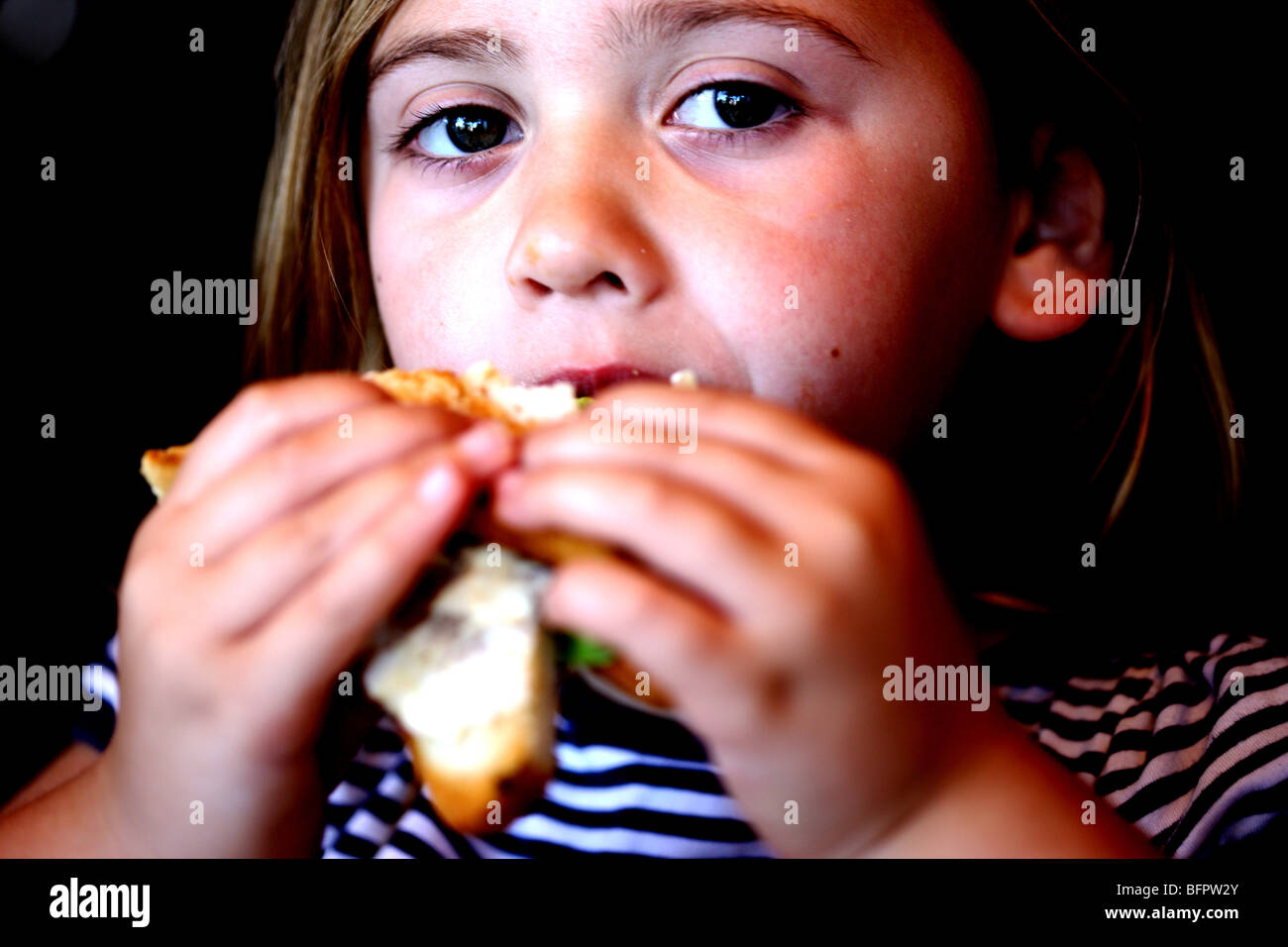 Young Girl Eating A Sandwich. Model Released Stock Photo - Alamy