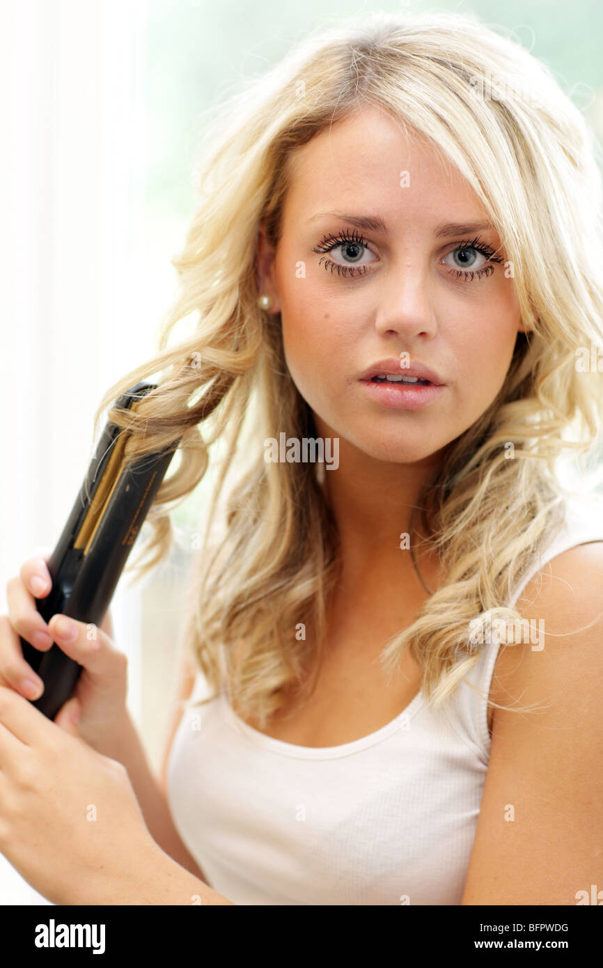 Teenage Girl Using Hair Tongs. Model Released Stock Photo - Alamy