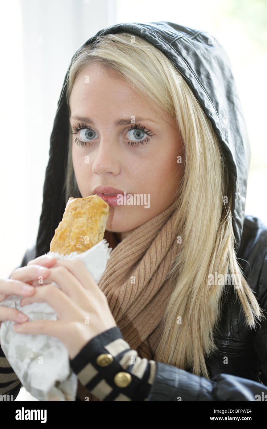 Teenage Girl Eating Saugage Roll. Model Released Stock Photo - Alamy