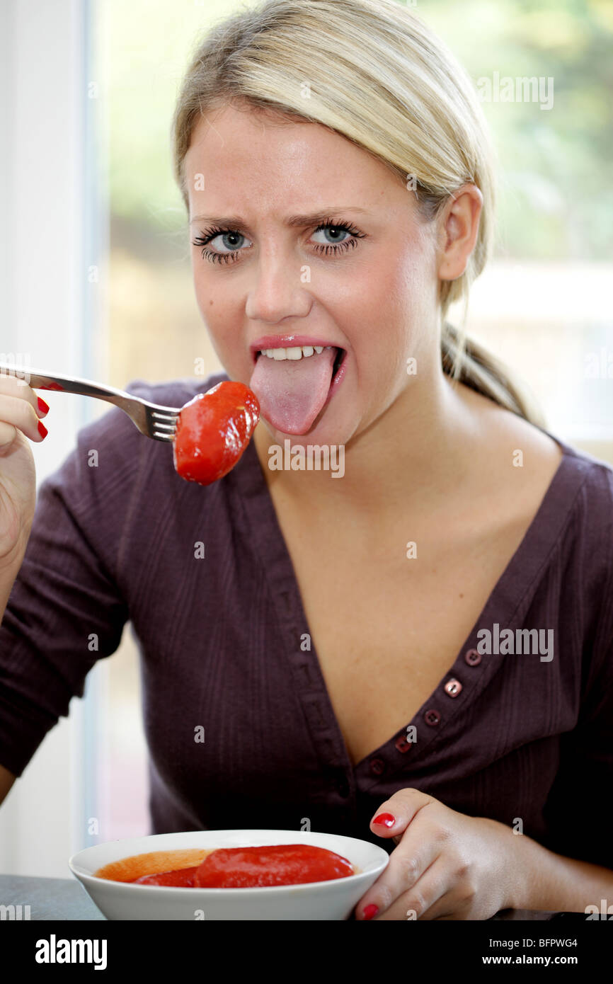 Teenage Girl Eating Tinned Tomatoes. Model Released Stock Photo - Alamy