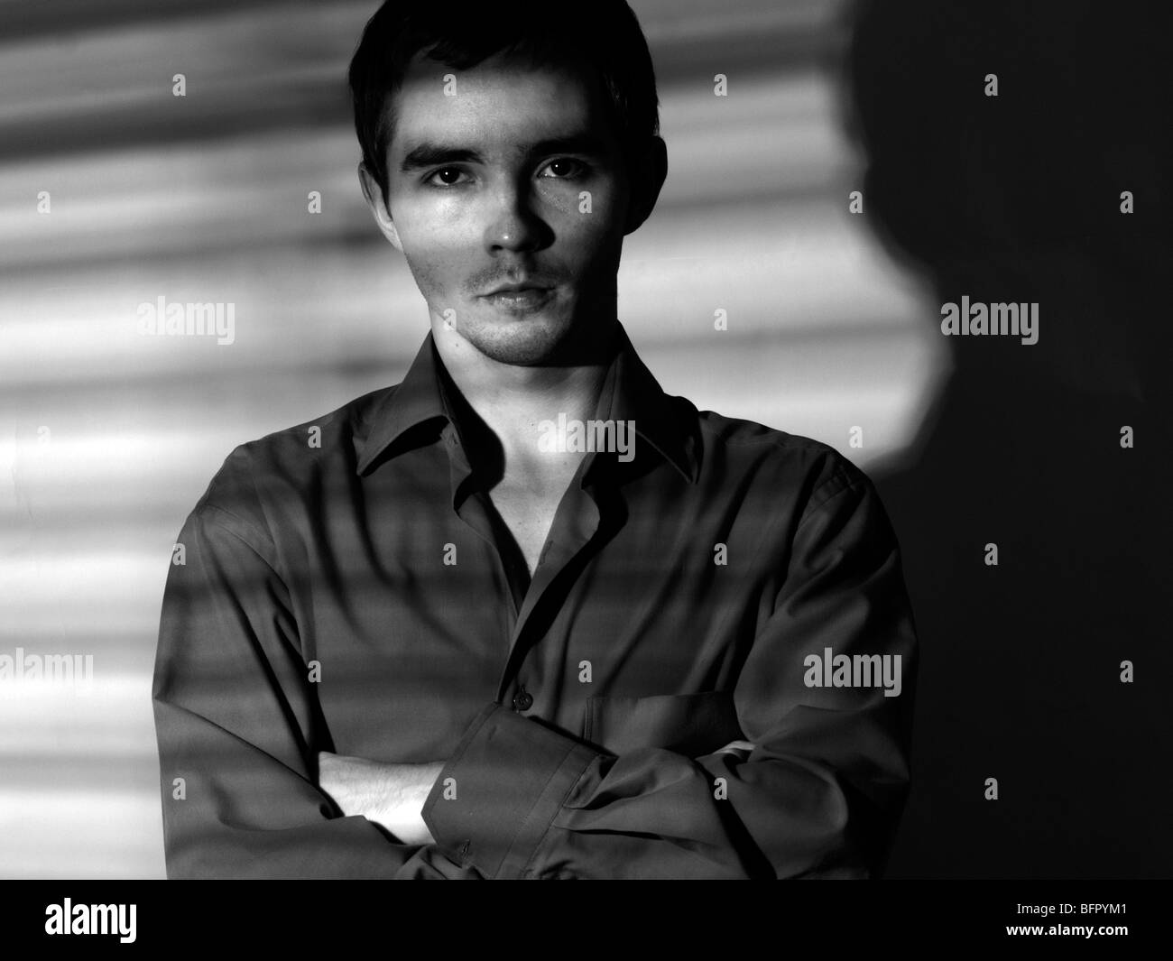 Young man serious black background isolated portrait Stock Photo - Alamy