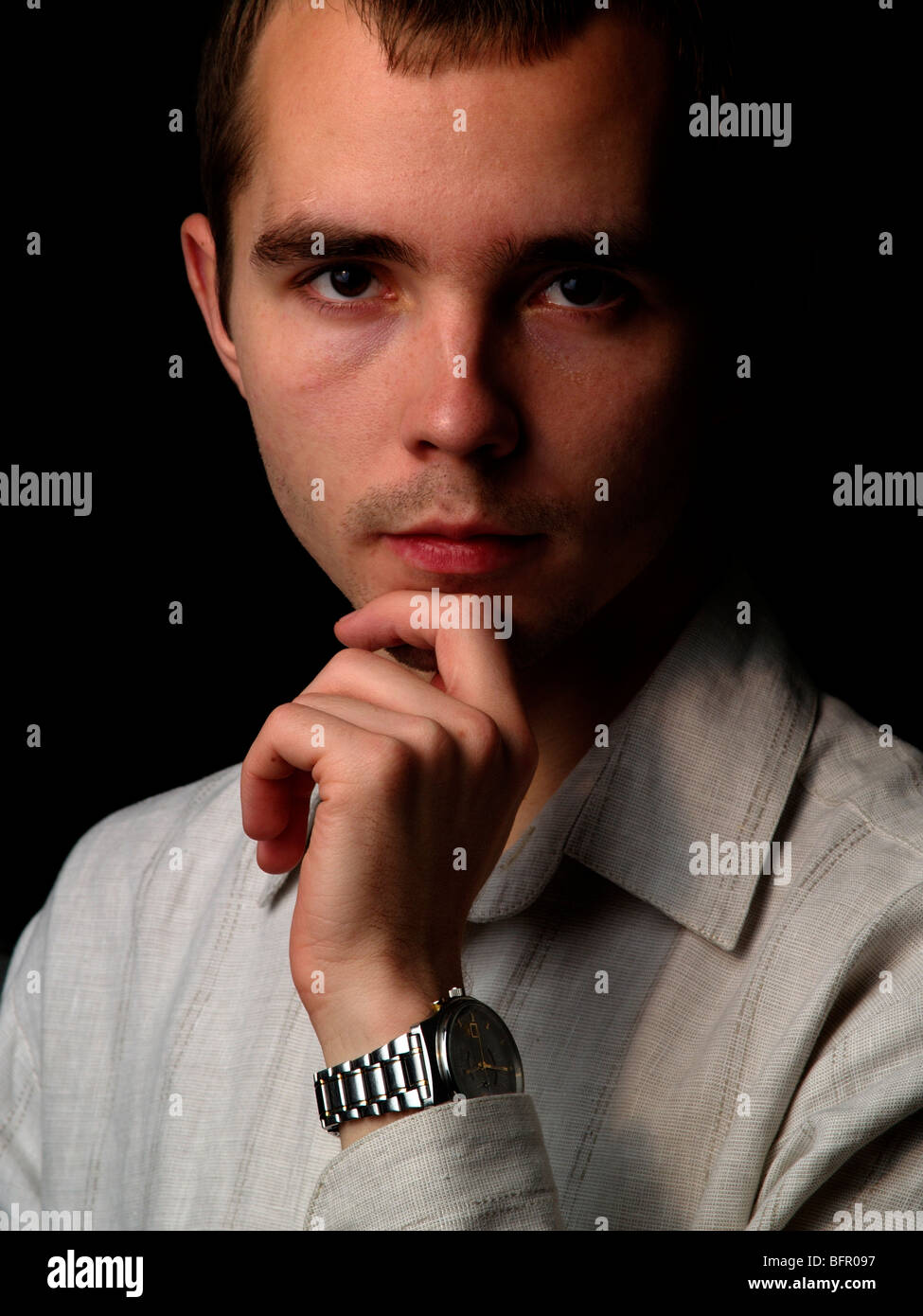 Young man thinking black background isolated portrait Stock Photo - Alamy