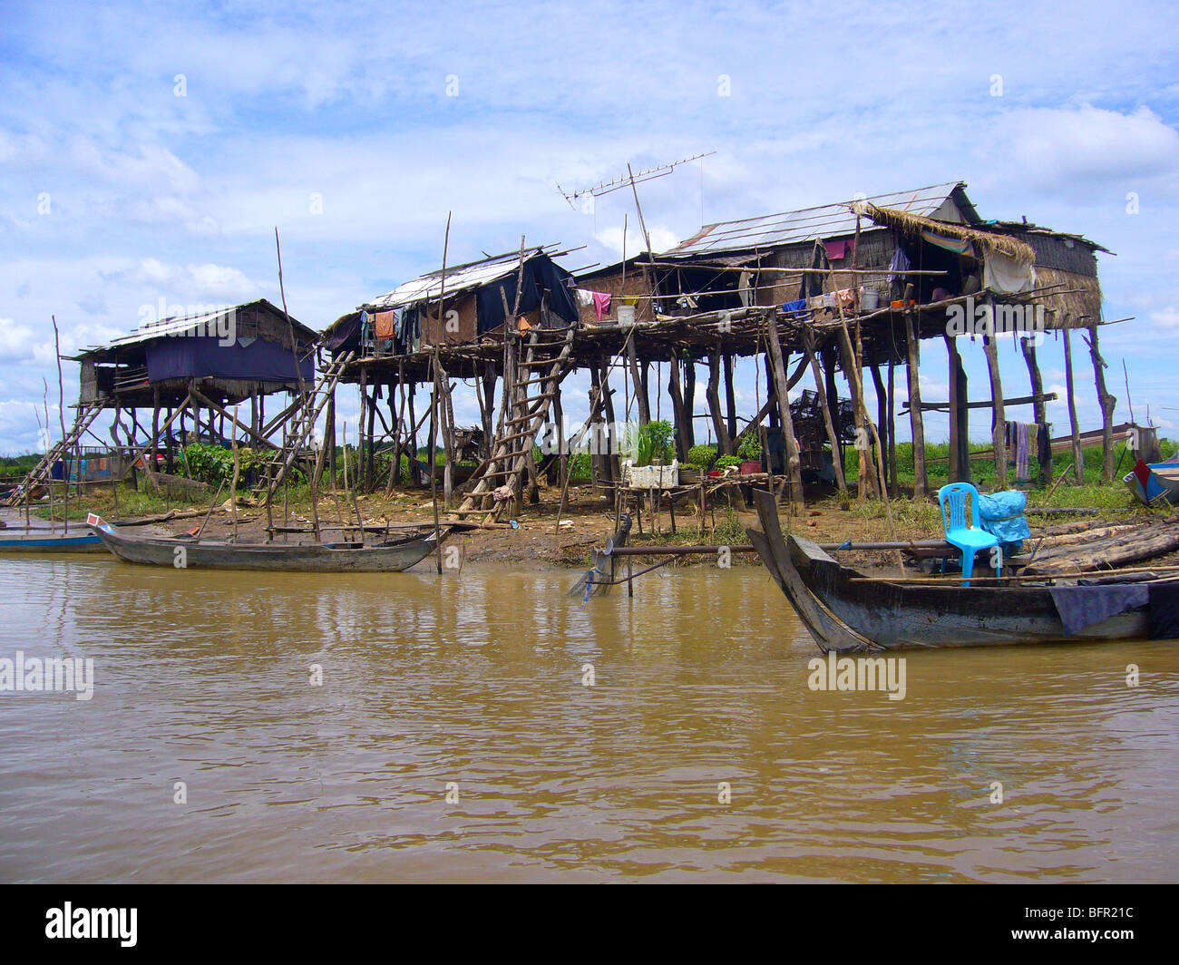 Stilted riverside dwellings line the Mekong River, one of the important ...