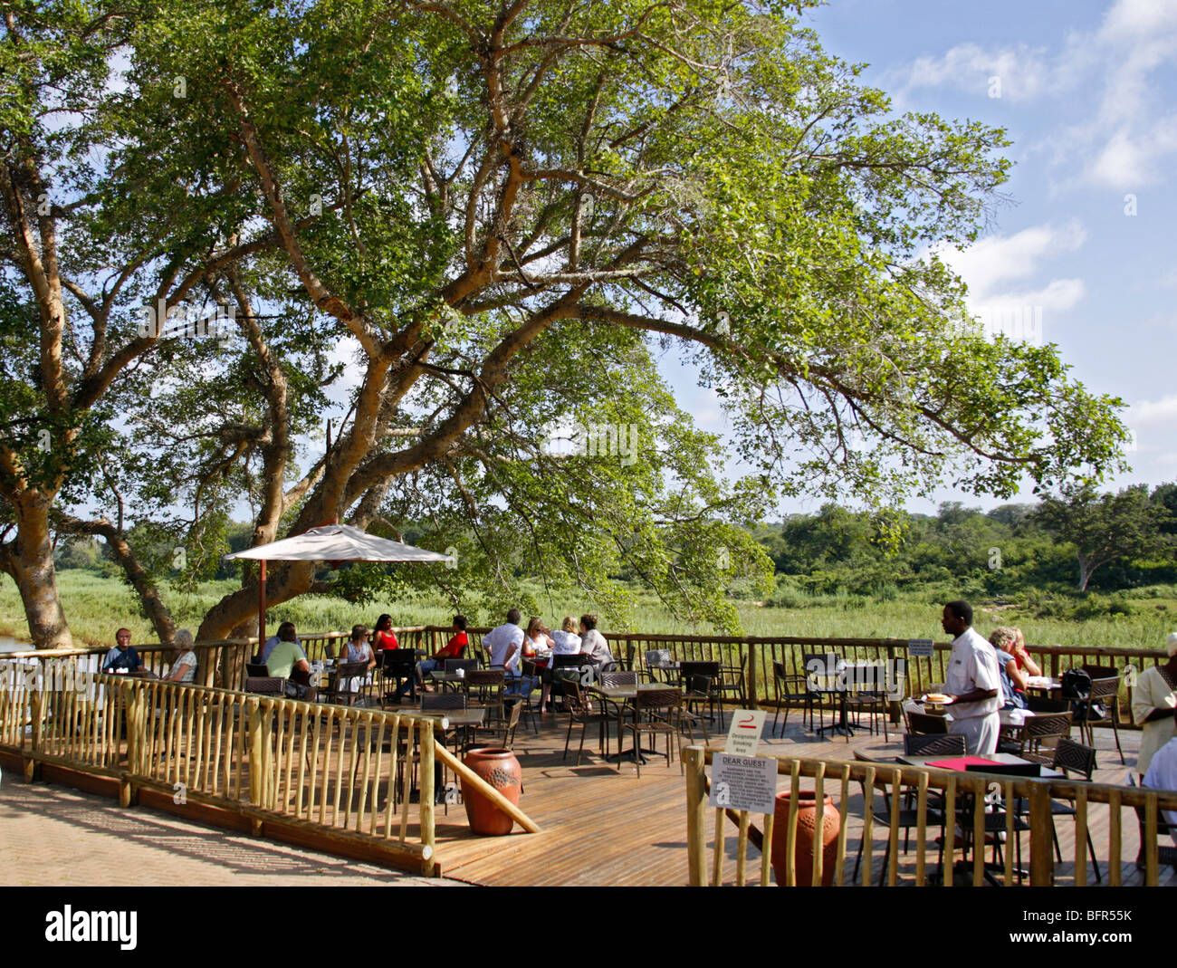 Tourists on the viewing deck in Skukuza overlooking the Sabie River in ...