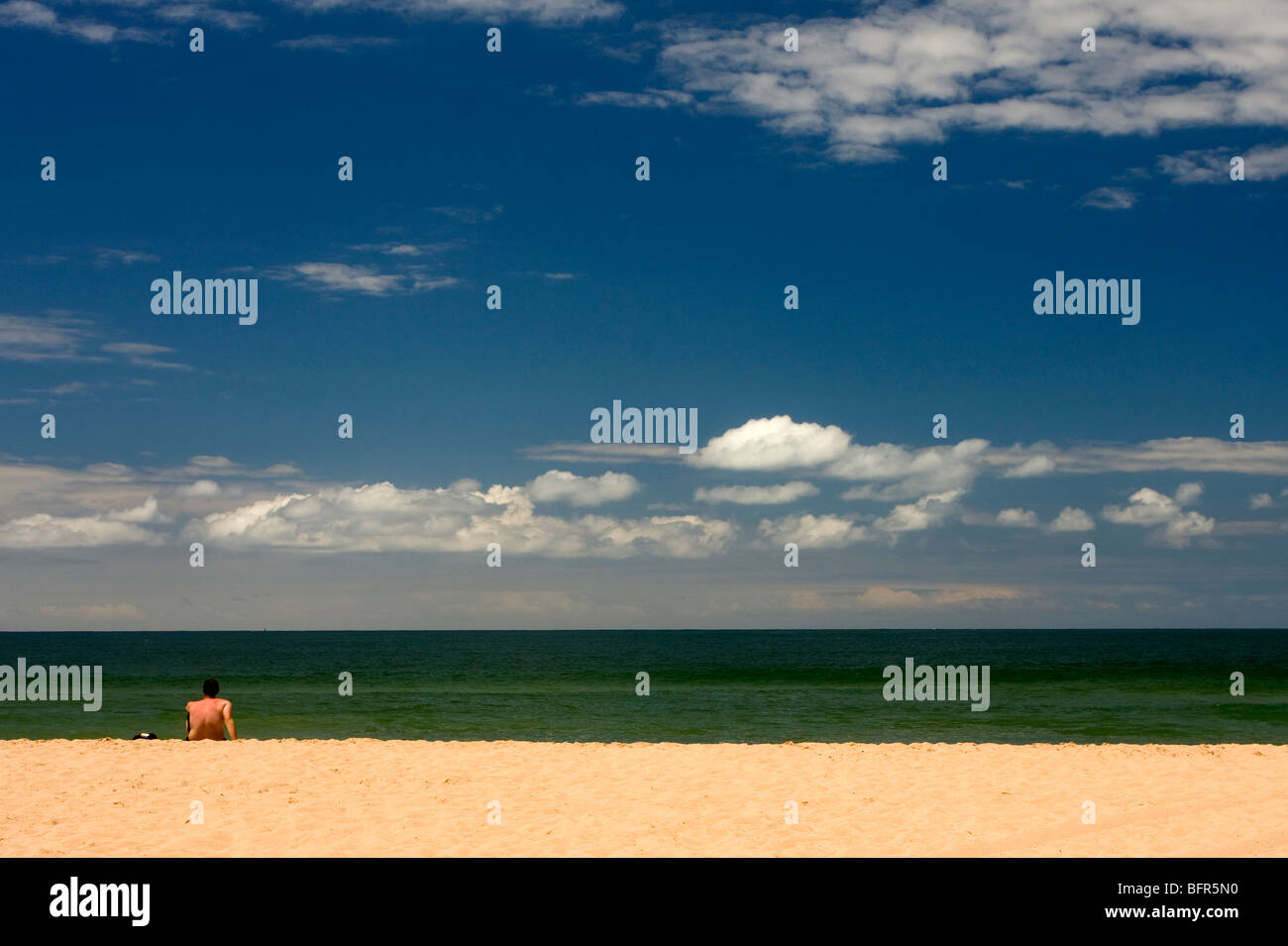 Lone bather looking out to the horizon on Pirate' Beach Stock Photo - Alamy