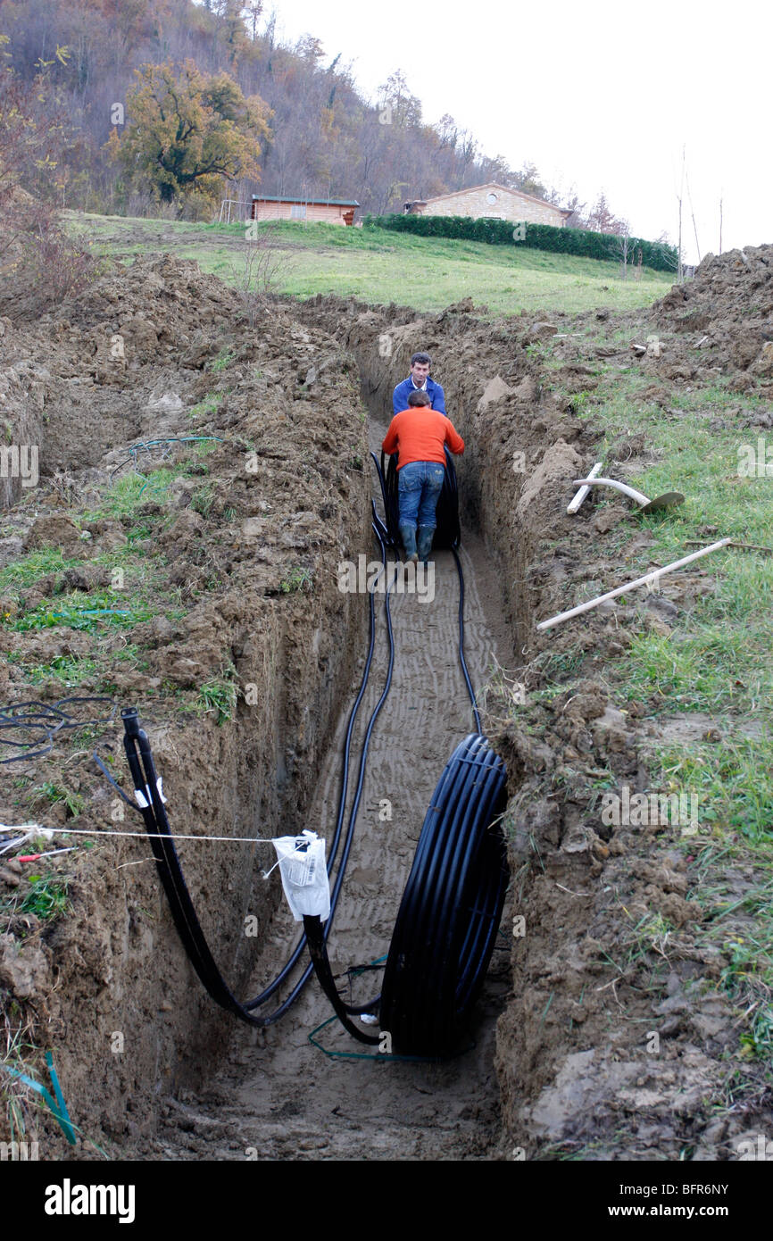 Geothermal Heating,polyethylene tube loops being installed in trench ...