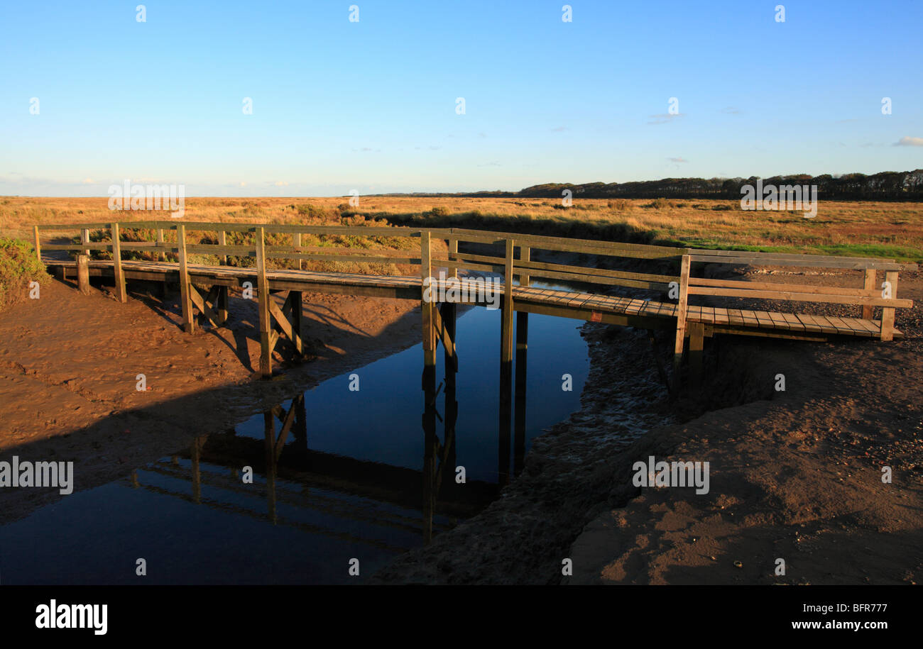 A wooden bridge across a creek at the salt marshes at Stiffkey Stock ...