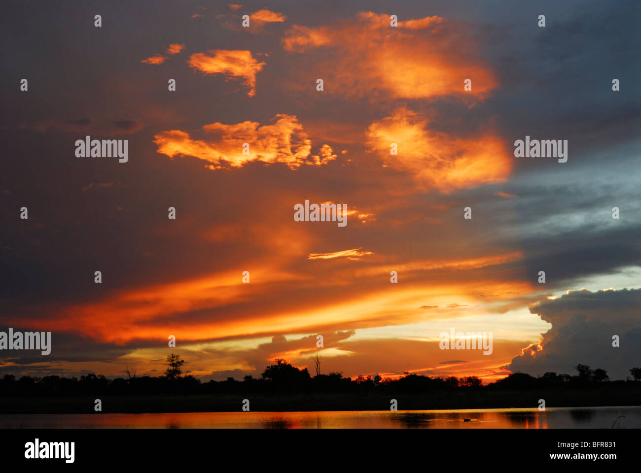 Moody sunset with dramatic illuminated clouds Stock Photo - Alamy