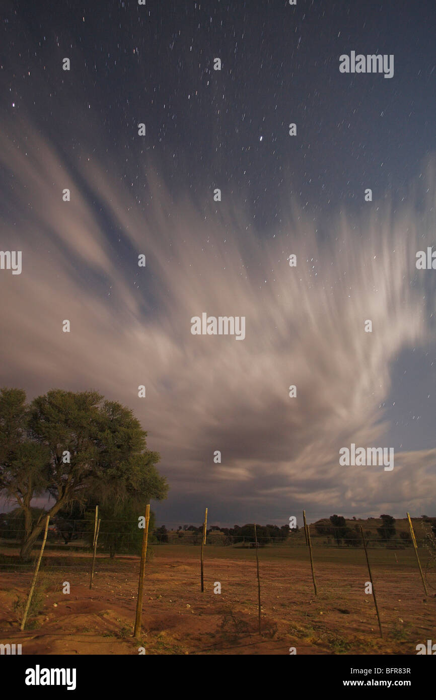 Landscape with streaky clouds and starry sky Stock Photo - Alamy