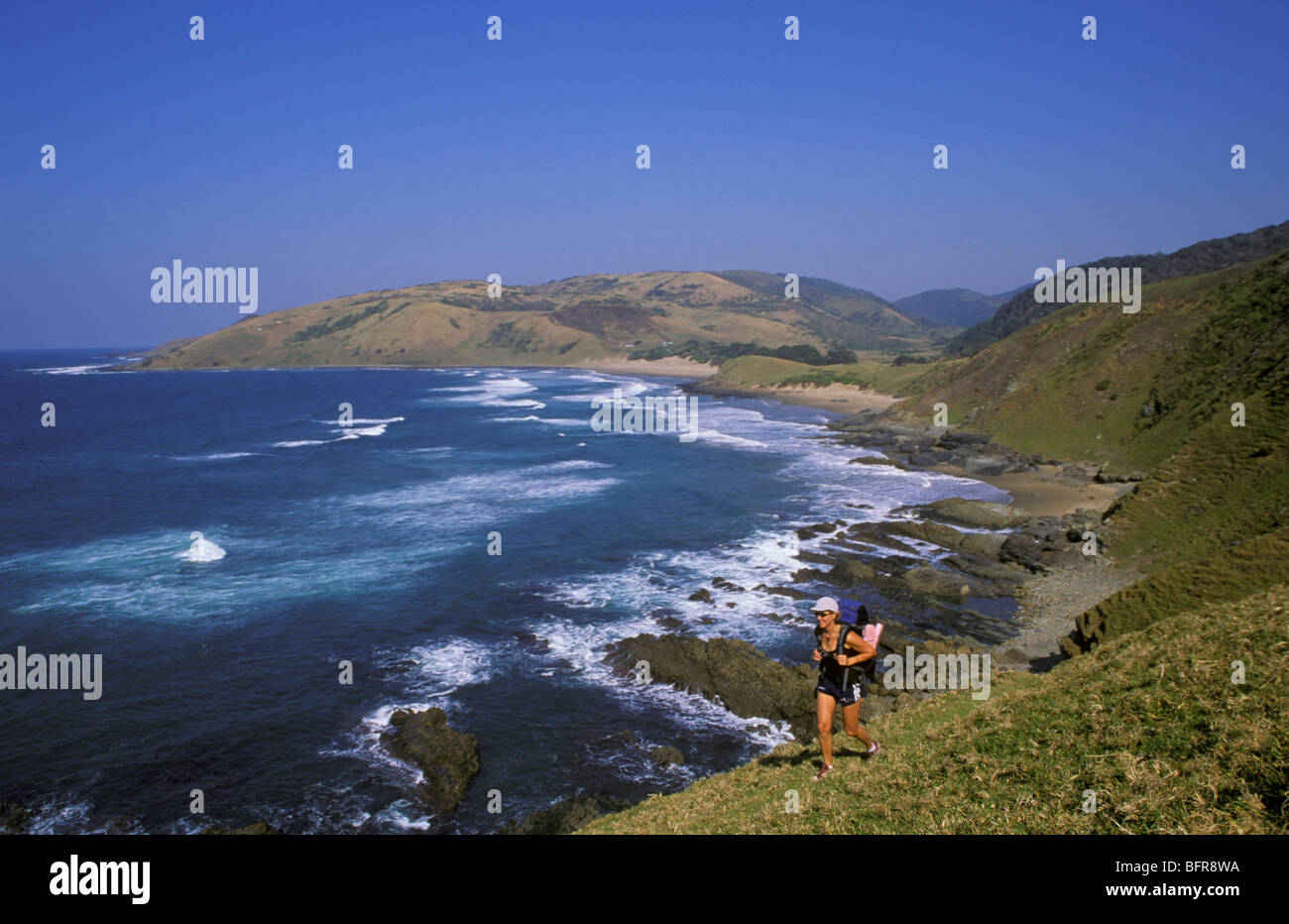 Hiker walking along the coast Stock Photo - Alamy