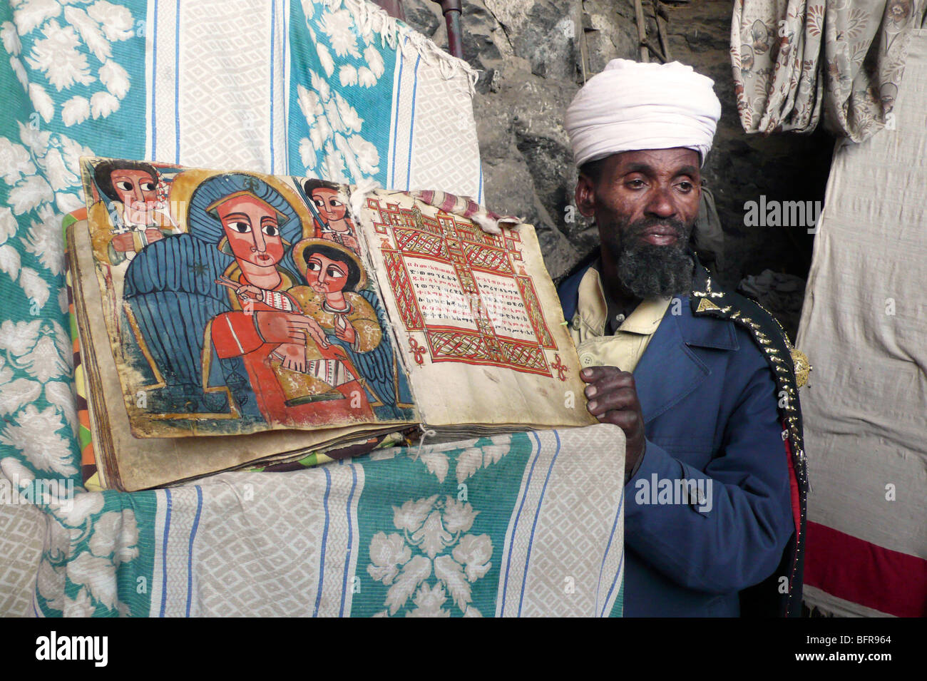 Coptic monk at the church of Na’Akuto La’Ab with ancient religious text ...