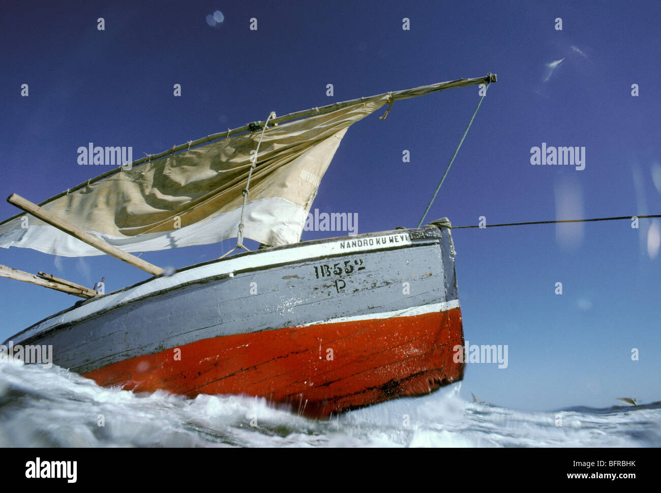 Dhow pushing through breaking wave Stock Photo - Alamy