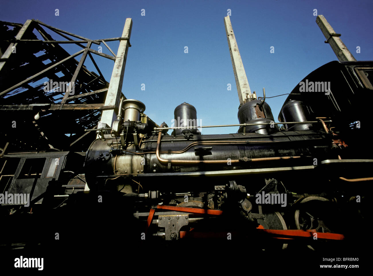 Old steam engine being repaired in disused railway station Stock Photo ...