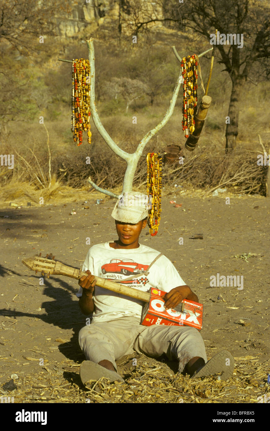 A San man Tsodilo Hills playing homemade guitar made out of tin can ...