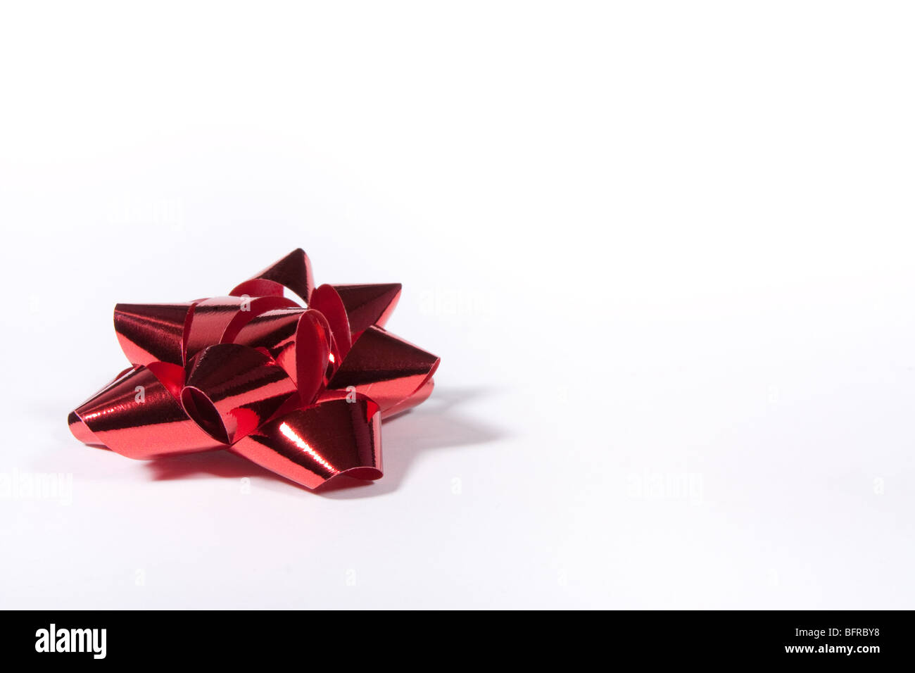 Red Shiny Gift Bow isolated against white background from low viewpoint ...