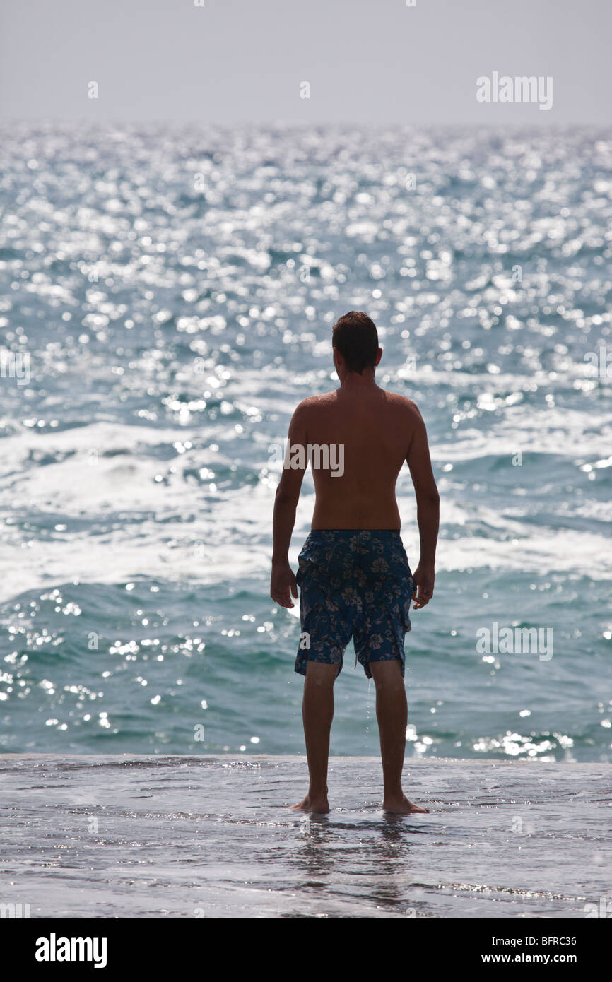 Man standing watching the sea Stock Photo - Alamy