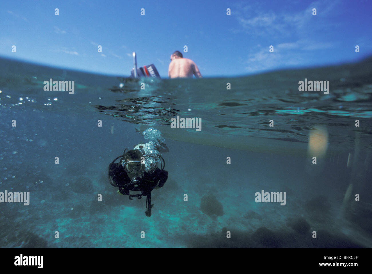 Diver underwater and man in dive boat Stock Photo - Alamy