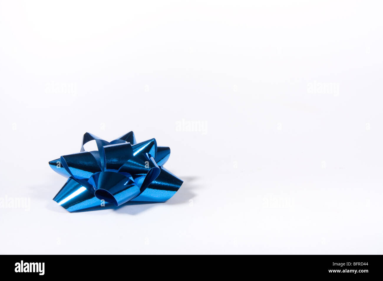 Blue Shiny Gift Bow isolated against white background from low ...