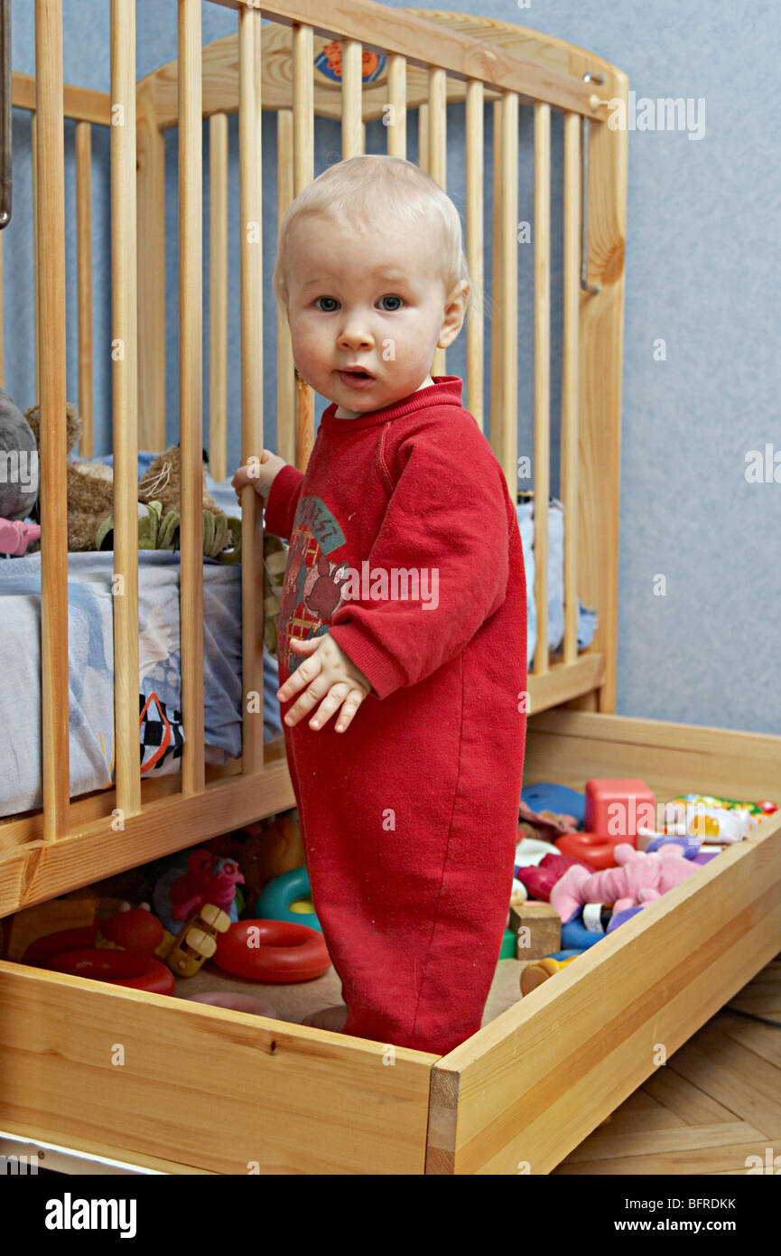 baby standing in the box with his toys Stock Photo - Alamy