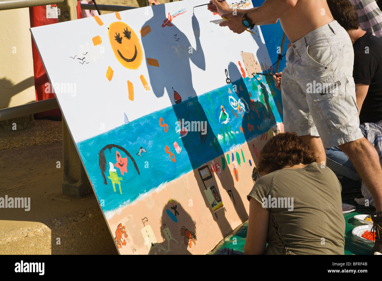 Street art. People painting a mural on Boscombe beach, depicting the ...