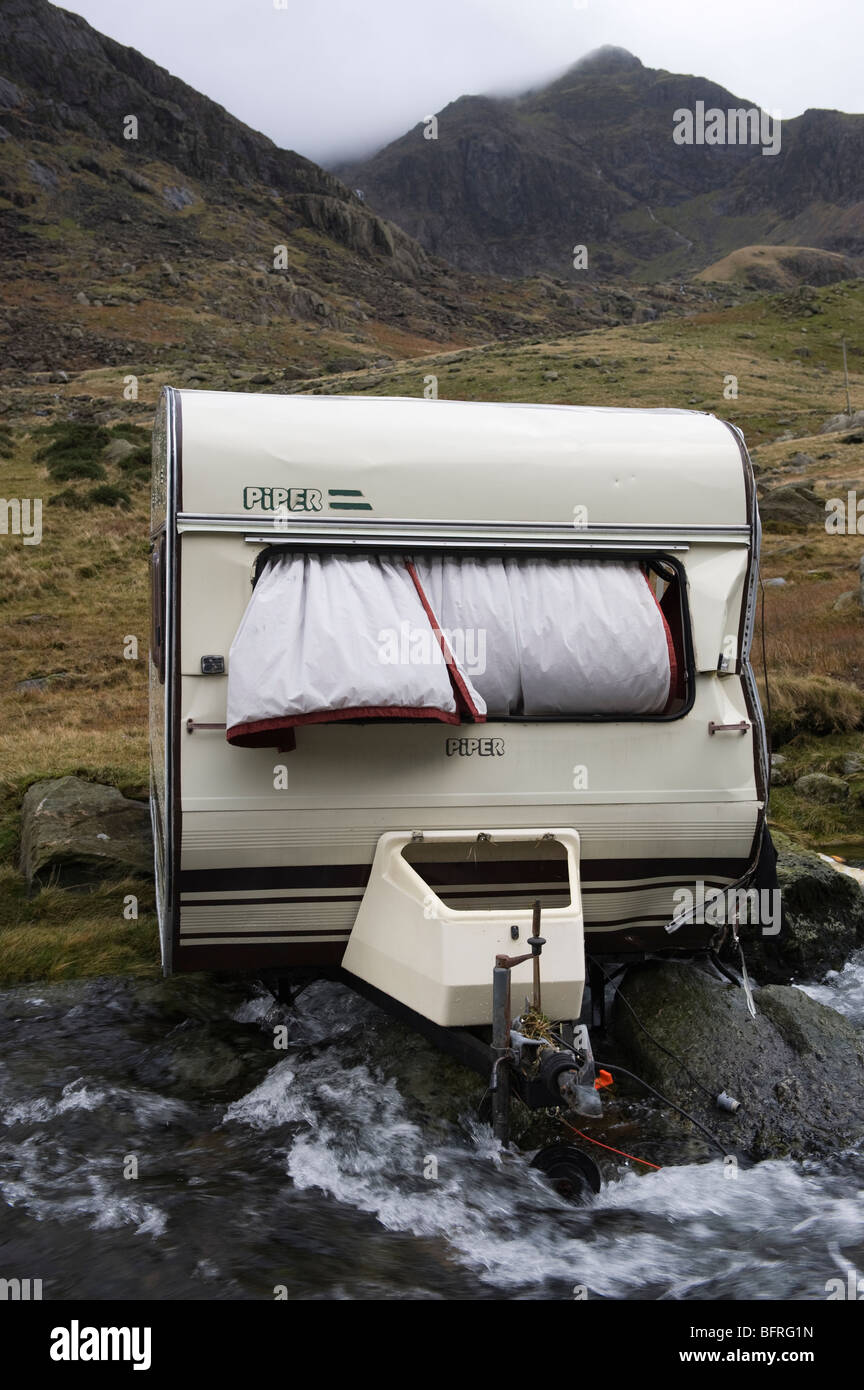 A caravan in the Llanberis Pass Snowdonia blown from the road over the ...