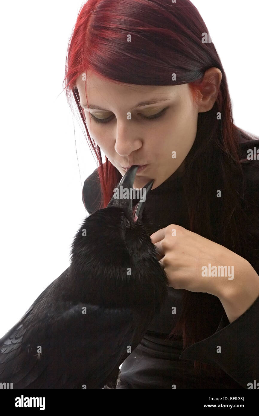young red-haired woman with big black raven on white background Stock ...