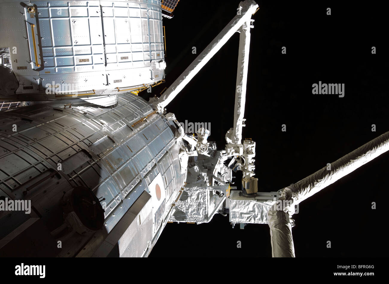 The robotic arm of the Japanese Experiment Module assists in installing ...