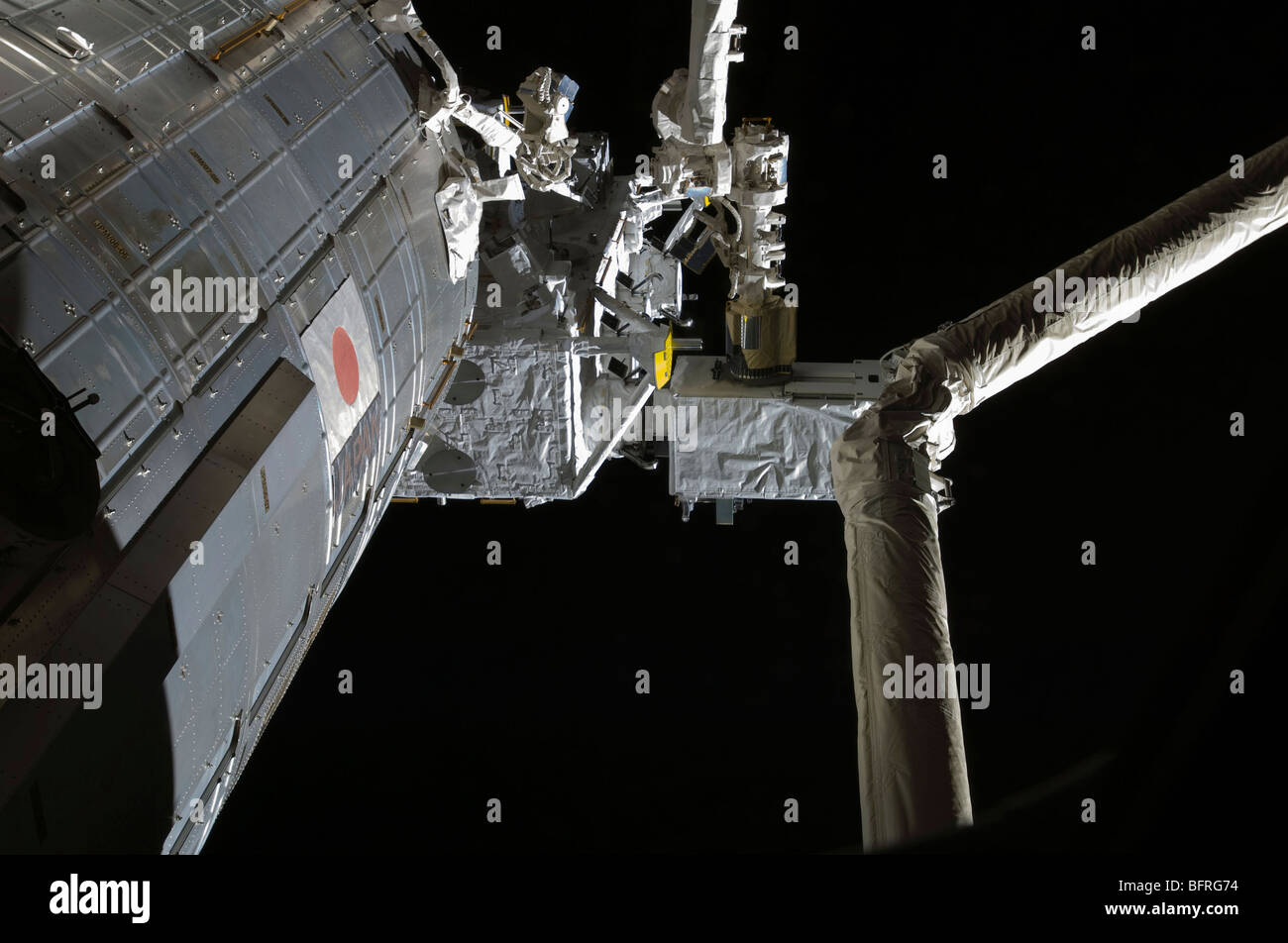 The robotic arm of the Japanese Experiment Module assists in installing ...