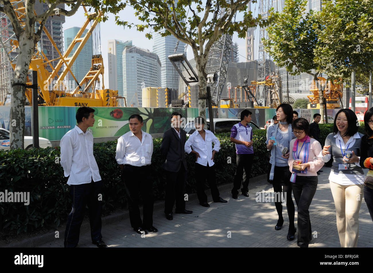 Businesswomen past young boys waiting for job interview outside an ...