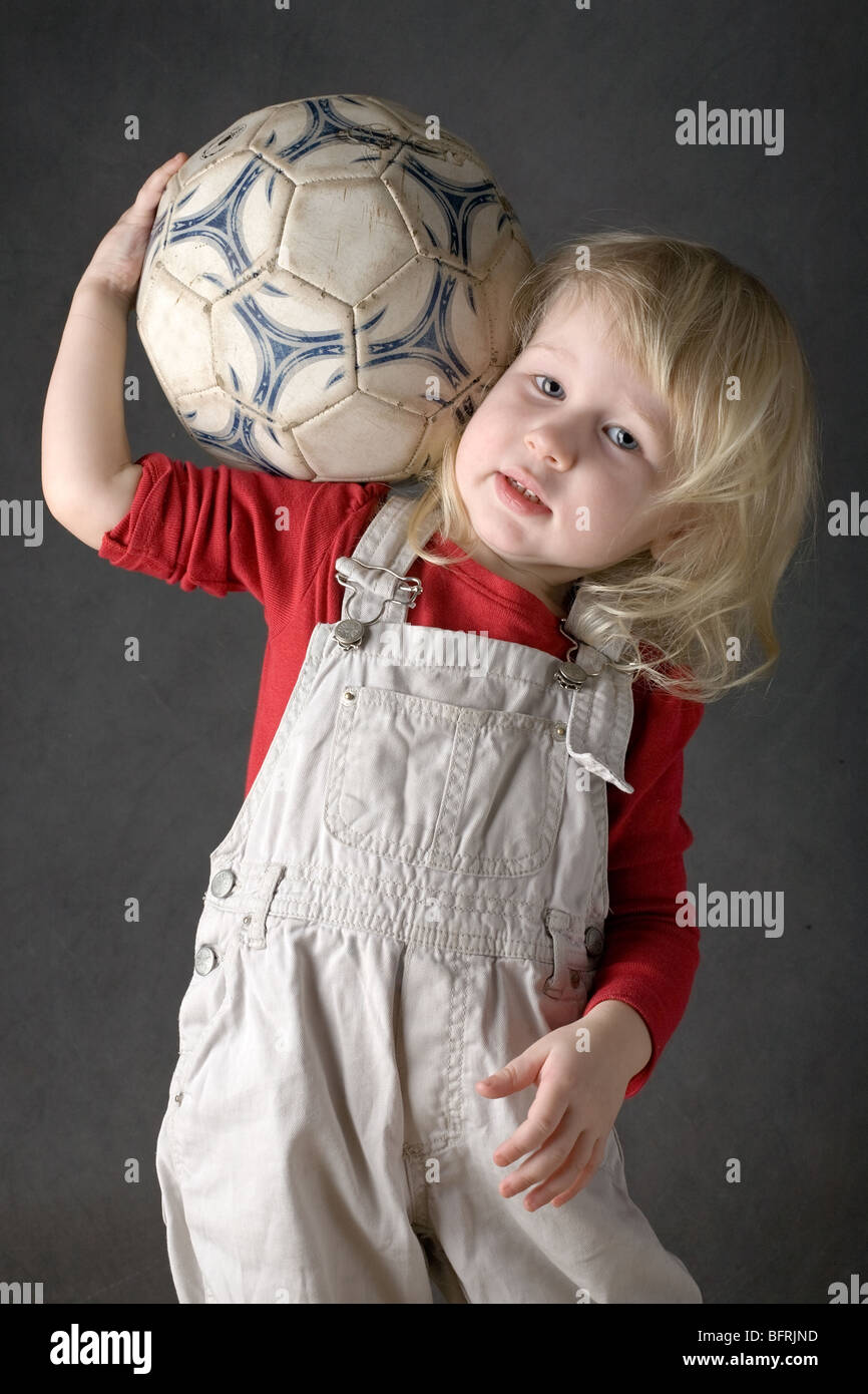 small beautiful strongman-footballer over grey Stock Photo - Alamy