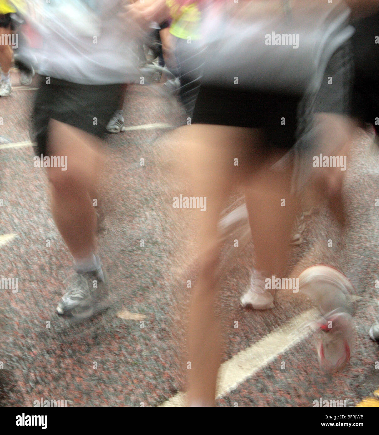 Two athletes running in a marathon side-by-side together Stock Photo ...