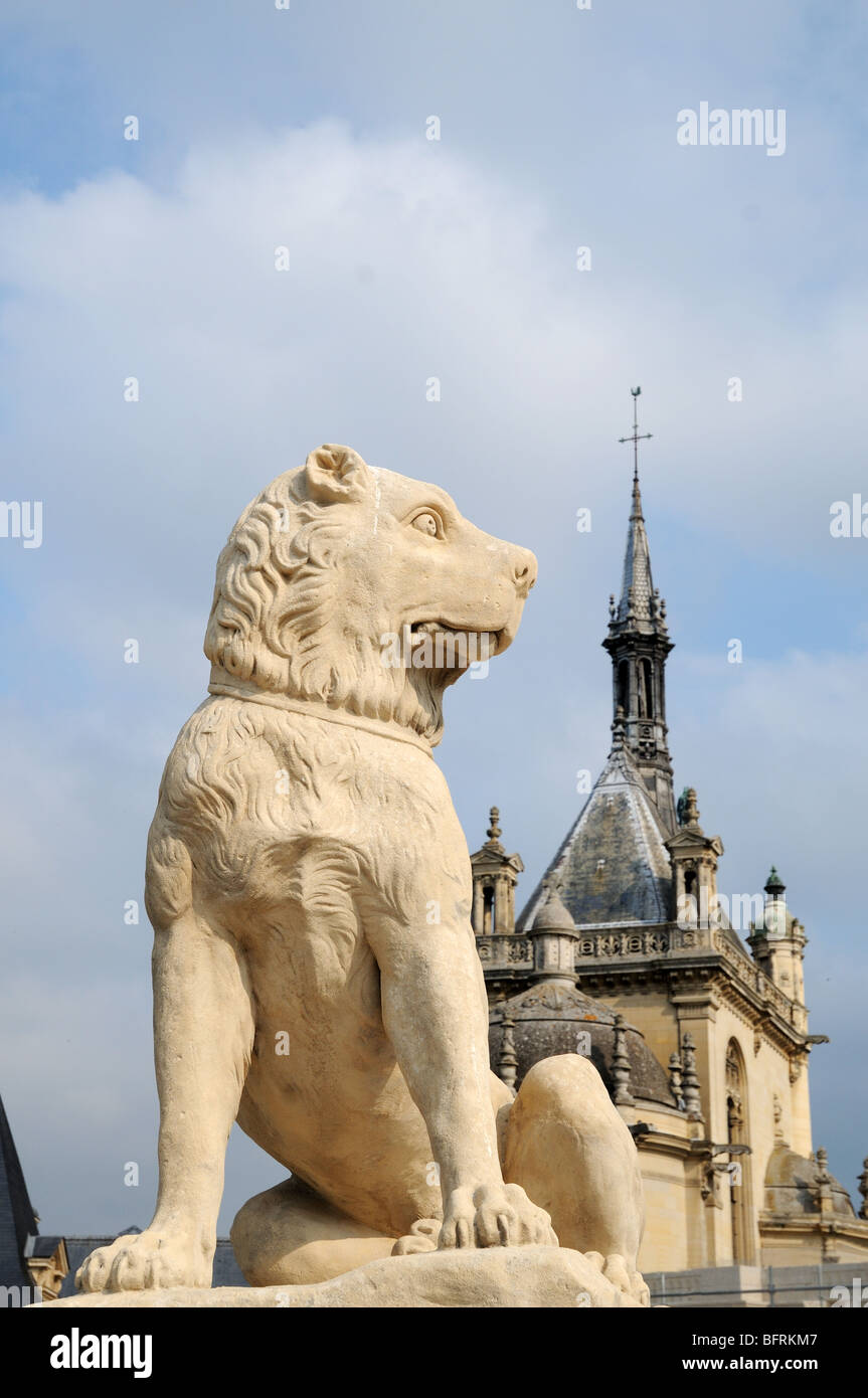 Carved stone statue of large mastiff dog on parapet of Chateau de ...