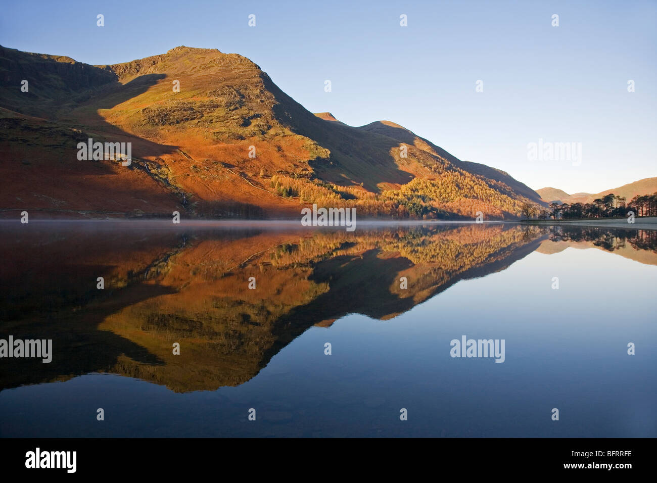 High Stile in Autumn colour reflection on the still calm surface of ...