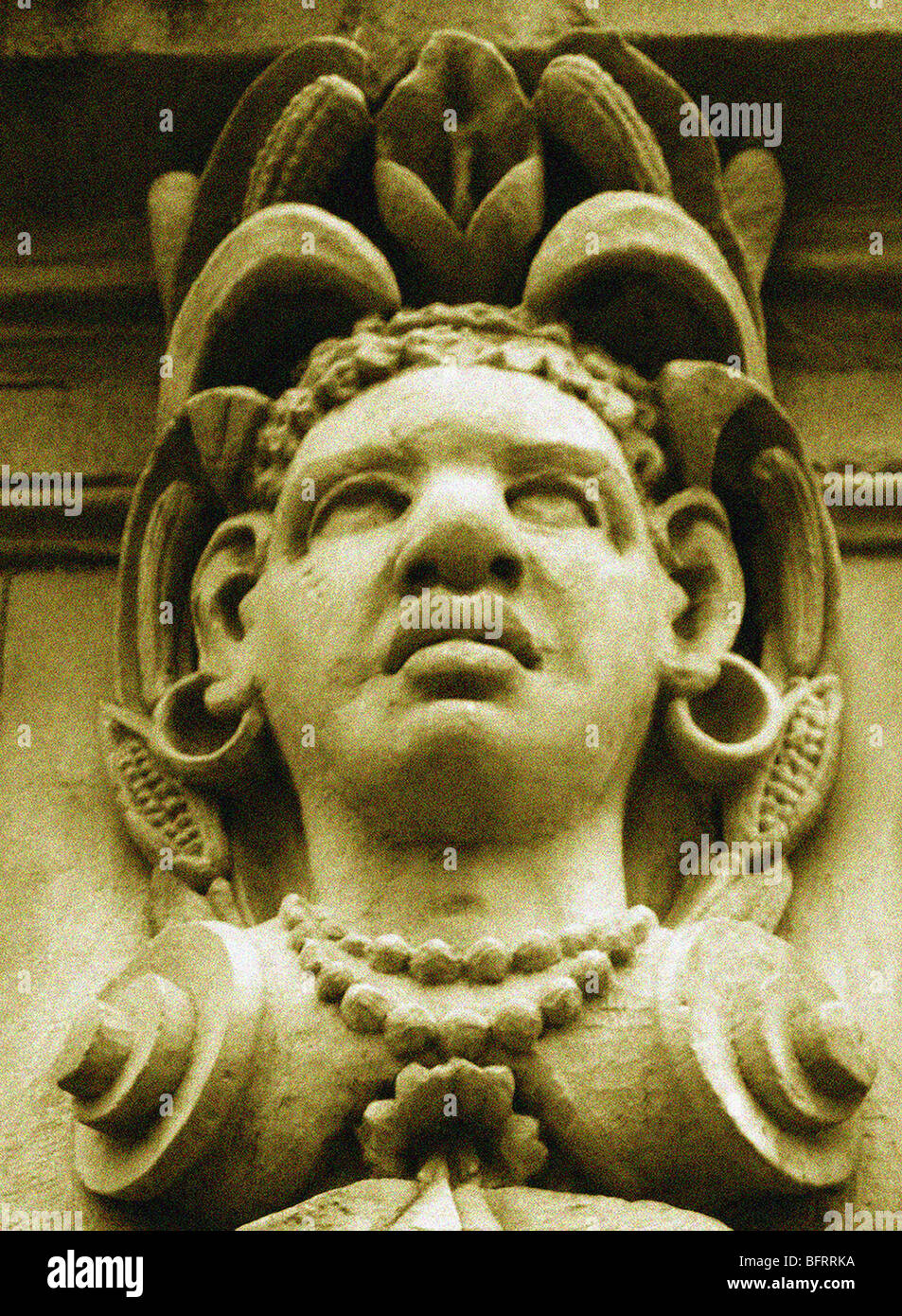 Stonework head carving of a native representing Africa located above ...