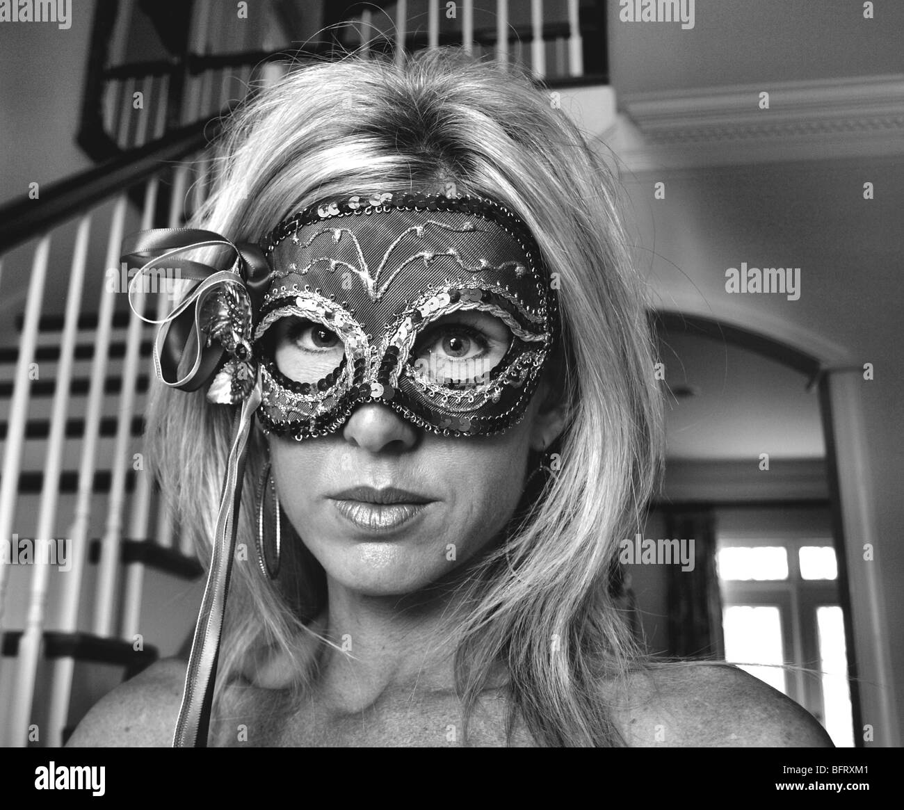 blond model in opera eye mask staring directly at camera blonde black ...