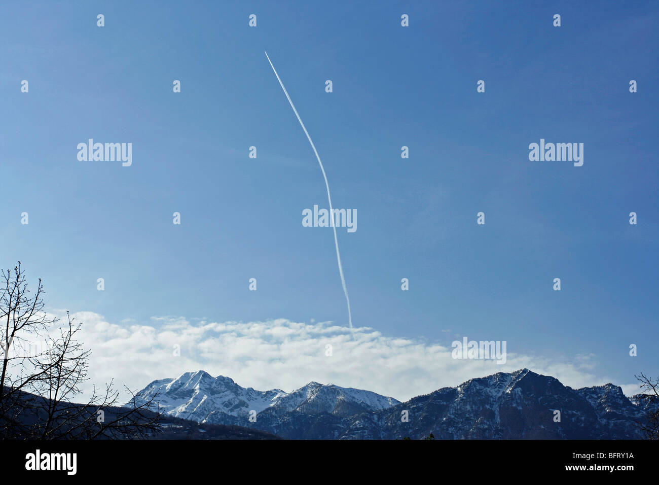 A jetplane flying over mountain top Stock Photo - Alamy