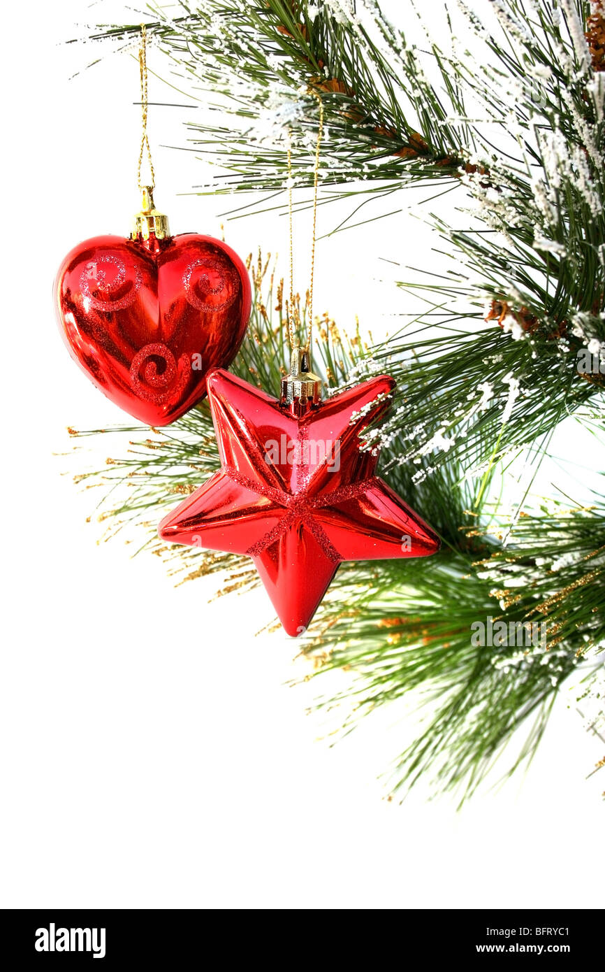 Christmas star and heart hanging on fir tree isolated on white ...
