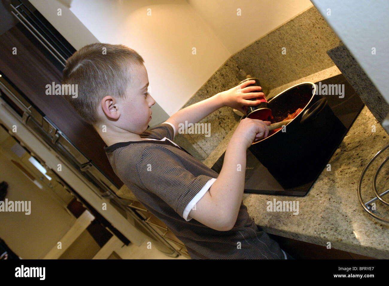 young child cooking over a stove Stock Photo - Alamy